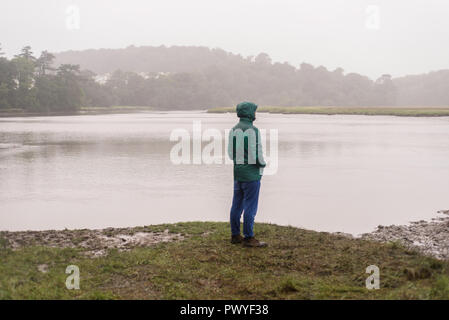 A Man Standing in the Mist Beide a Lake Stock Photo - Alamy