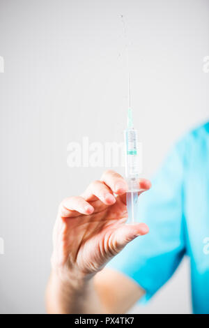 woman nurse or doctor is tapping a syringe preparing an injection Stock ...