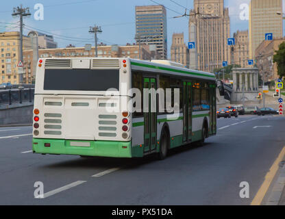 white city bus goes along street Stock Photo - Alamy