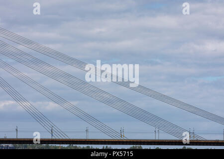 A part of a bridge with wires on a cloudy background Stock Photo - Alamy