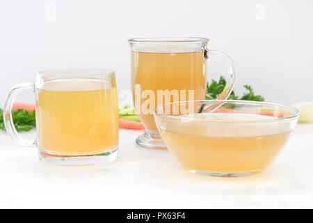 Chicken Stock in Glass Mugs and Bowl Stock Photo - Alamy