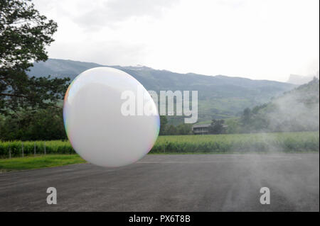 Switzerland, Wallis, artificial white air bubbles from bubble machine ...