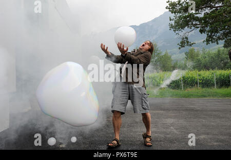 Switzerland, Wallis, artificial white air bubbles from bubble machine ...