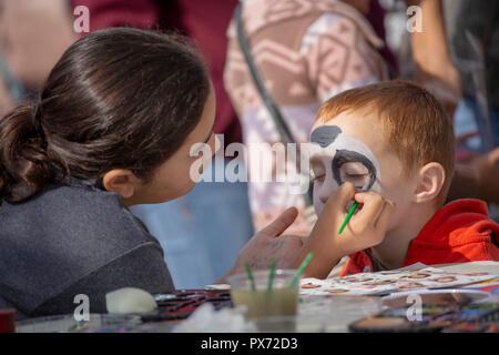 Girl getting face painted Stock Photo - Alamy