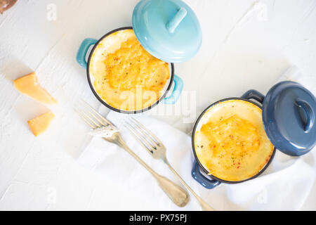 Seafood concet with mussels and cheese in bowl on white concrete ...