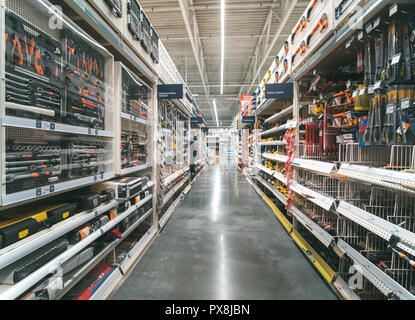 Aisle in a warehouse hardware store with goods on shelves and in boxes ...