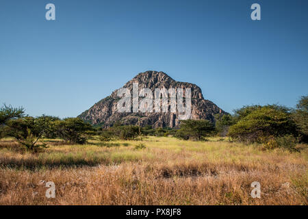 A view of the male hill at Tsodilo Hills, glowing pink during sunset ...