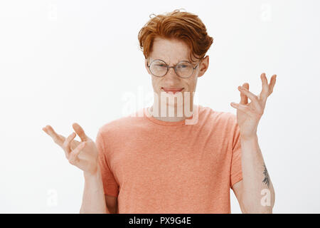 Displeased and disappointed man in orange sweater, grimacing and ...