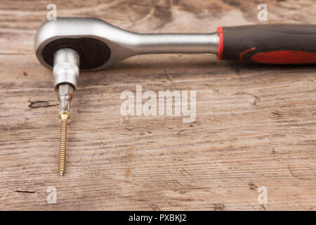 Key with the head for screwing lies against the background of the ...