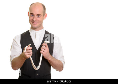 Bald Caucasian magician man holding rope for magic trick Stock Photo ...