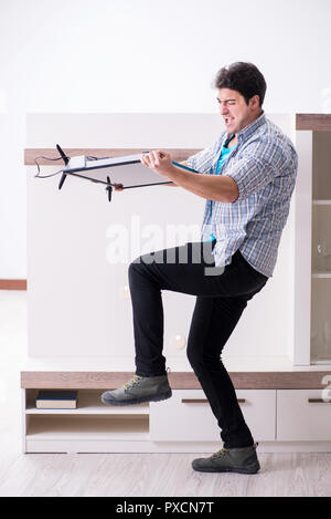 Man trying to fix broken tv Stock Photo - Alamy