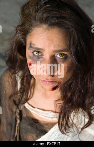 Homeless young woman dressed in rags in a derelict building Stock Photo ...