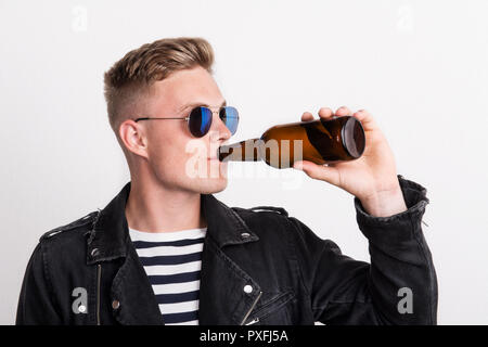 portrait of a teenage boy drinking beer Stock Photo - Alamy