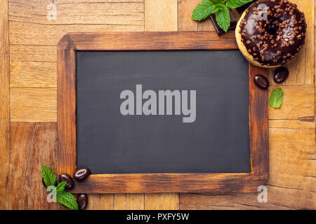 Black chalkboard with chocolate glazed donut Stock Photo - Alamy