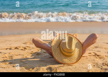 Young dutch man with hat lying on sea beach Stock Photo - Alamy
