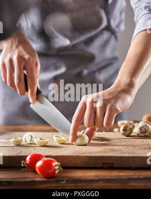 Wooden hand with quail egg on dark background Stock Photo - Alamy