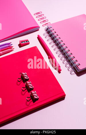 Notebooks and pencil on pink background, closeup Stock Photo - Alamy