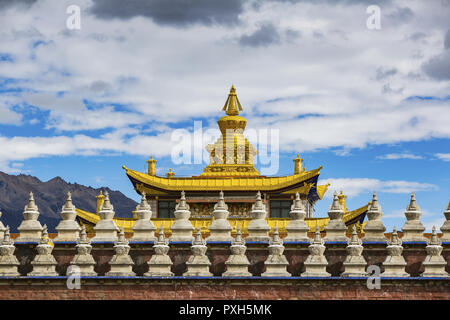 Muya Golden Tower against the sky with white cloud in front of Yala ...