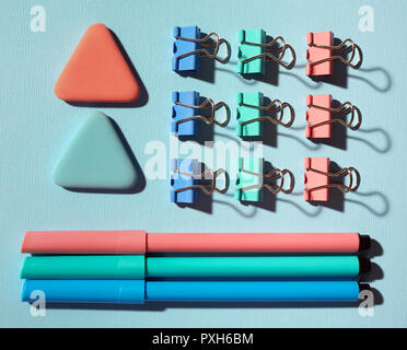 A top view of a paper stapler, paper clips, pens, and other objects on ...