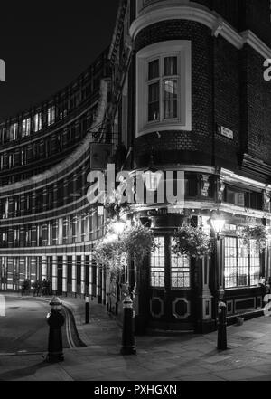 Hanging flower baskets on the exterior of Churchill Arms pub in Stock ...