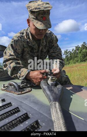 U.S. Marine Lance Cpl. Jess Barrett, a heavy equipment operator with ...