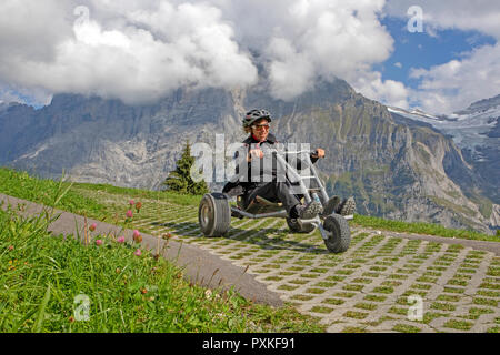 Riding a mountain cart from First cable-car station above Grindelwald ...