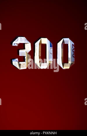 Three hundred euros in folded paper money Stock Photo - Alamy