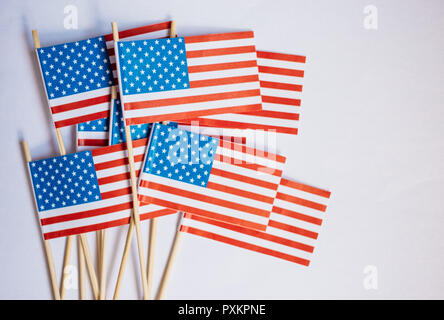 Miniature paper flags USA. American Flag on blurred background outdoors ...