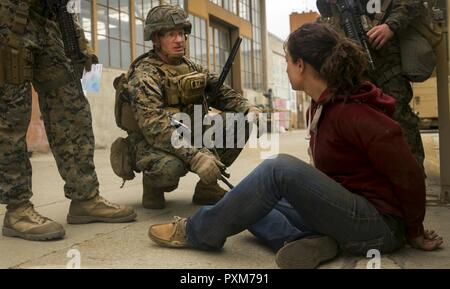 U.S. Marine Gunnery Sgt. Ryan Slusher watches his platoon work with the ...