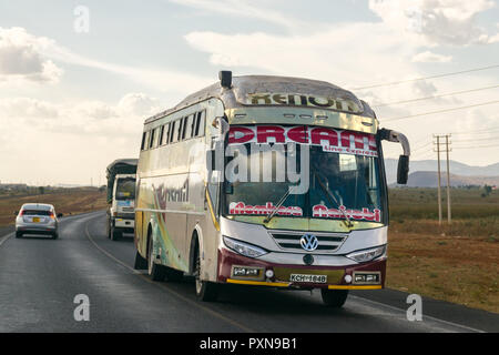 A large colourful bus drives along a stretch of Mombasa road, Kenya ...