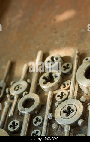 Threading dies on rusty metal surface close-up Stock Photo - Alamy