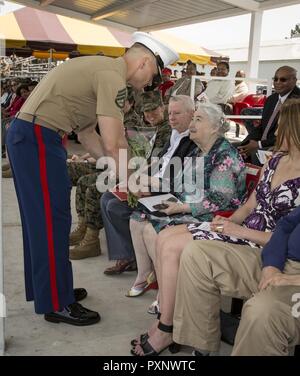 Flowers are presented to U.S. Marine Corps Lt. Col. Anthony D. Ramey’s ...