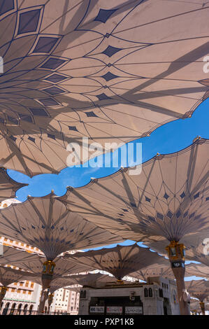 Giant canopies at Nabawi mosque in Medina, Saudi Arabia.during sunrise ...