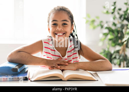 A cute Black girl doing homework at home Stock Photo - Alamy