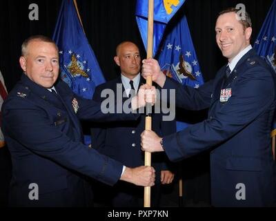 Col. Robert Stanton, left, the 302nd Operations Group commander, passes ...