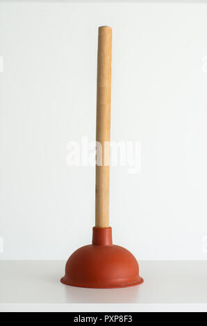 Bright red rubber plunger with wooden handle isolated on white Stock ...