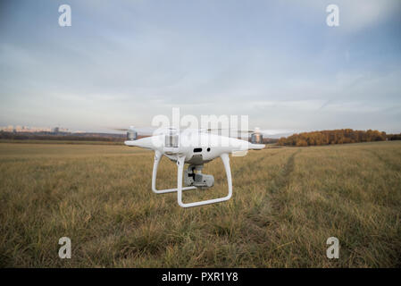 Demonstration flight drone DJI Phantom 4 Pro in the autumn forest ...