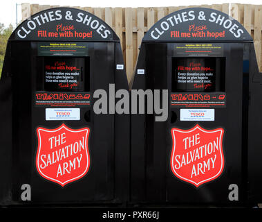 Charity clothes and shoes collection bins in a council carpark in Wales ...