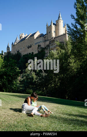 Mother and grownup daughter resting on couch with computer Stock Photo ...