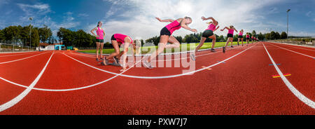 Female runner in starting position on running track Stock Photo - Alamy