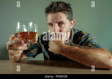young drunk and pissed alcoholic man wasted wearing dirty singlet drinking whiskey glass ...