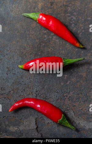 Three red chilli peppers on white background Stock Photo - Alamy