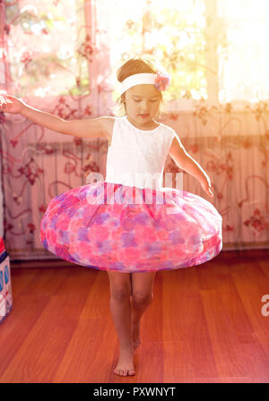 little girl dreams of becoming a ballerina. Child girl in a blue ballet ...