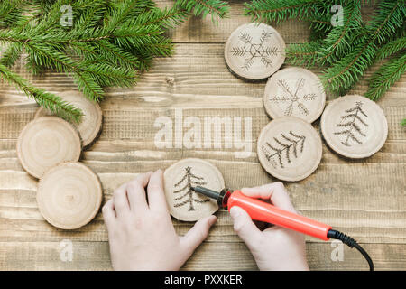 Christmas or New Year homemade pyrography toys. Wooden slice ...