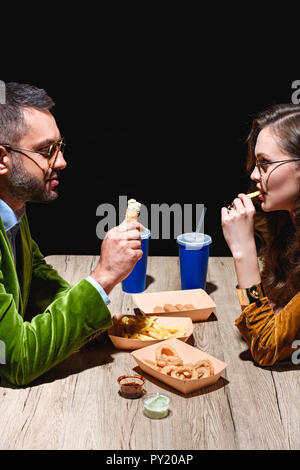 caucasian couple eating french fries in fast food and have fun Stock ...