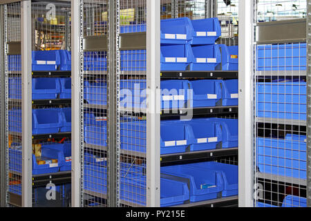Blue plastic sort boxes in shelf Stock Photo - Alamy