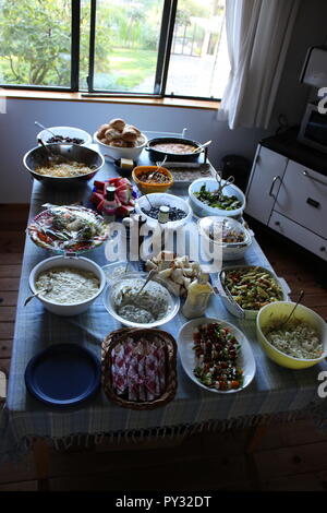 Table with potluck spread food dishes Stock Photo - Alamy