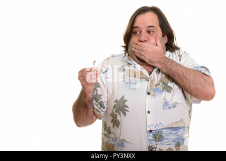 Fat Caucasian man eating spicy chili pepper looking nauseous Stock ...