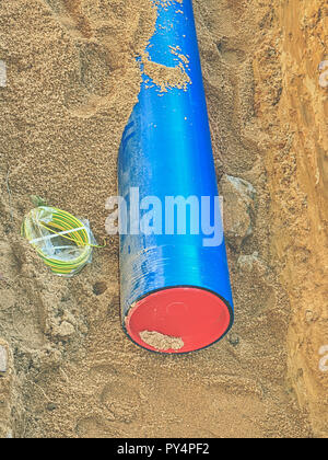 Work in burying water supply pipeline in a urban area. Service of city ...