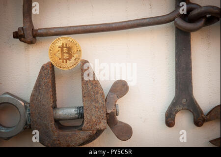 Bit coin with different tools on wall Stock Photo - Alamy